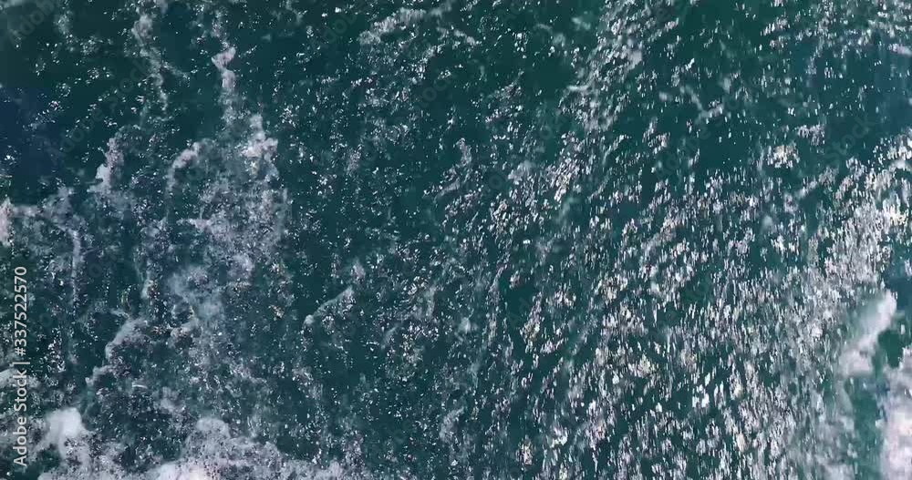 Raging stream of sea water from under the boat, water of azure color ...