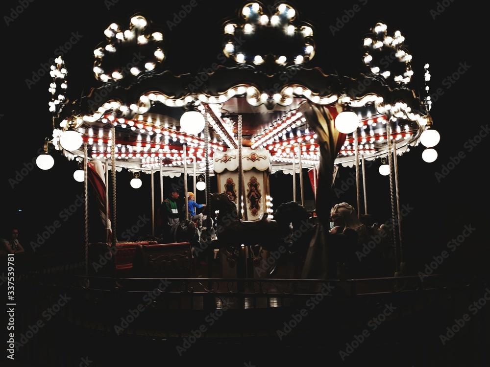 Illuminated Carousel In Amusement Park At Night Stock Photo | Adobe Stock