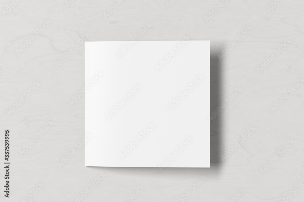 Blank square pages leaflet on white wooden background. Bi-fold or half ...