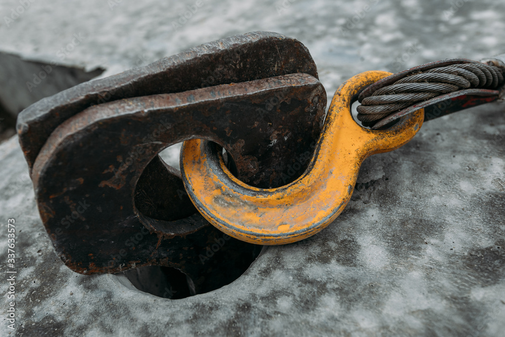 yellow hook securing concrete parts of a house at a construction site ...