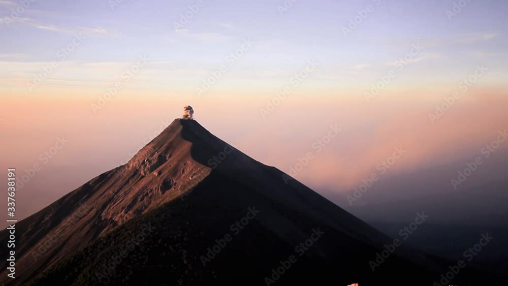 Vidéo Stock Fuego volcano erupts during colorful sunrise. Wide shot of ...