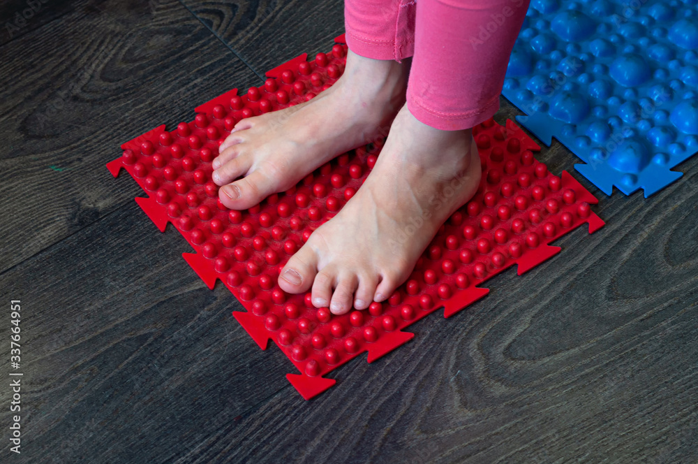 Foto de barefoot girl walks on sensory mats in the sensory integration room do Stock | Adobe Stock