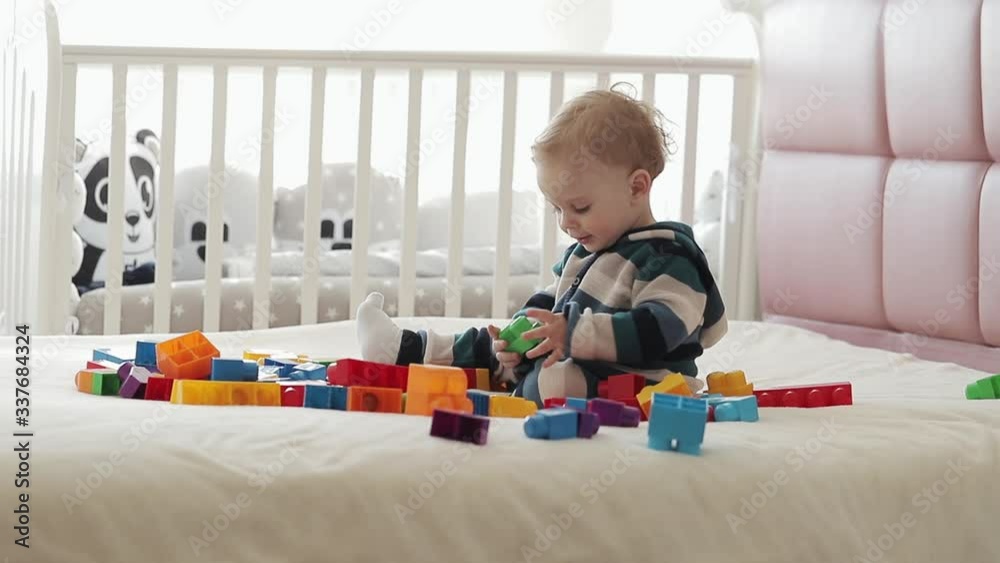 Toddler having fun and building out of constructor bricks. Early ...