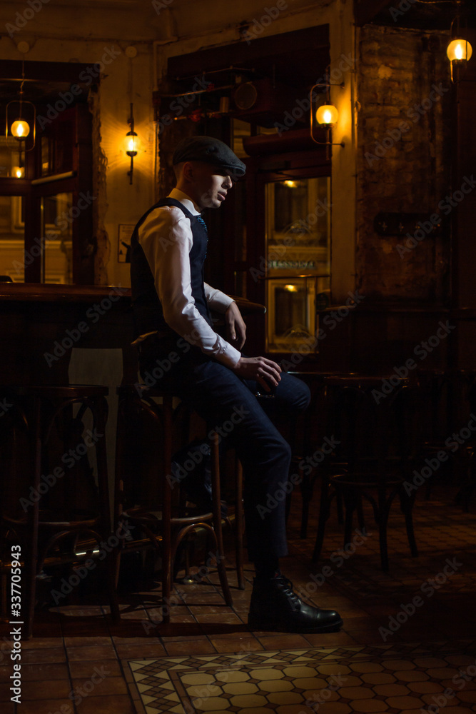 Young man in retro pub Stock Photo | Adobe Stock