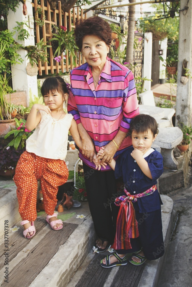 Full Length Portrait Of Grandmother With Grandchildren On Steps Stock ...