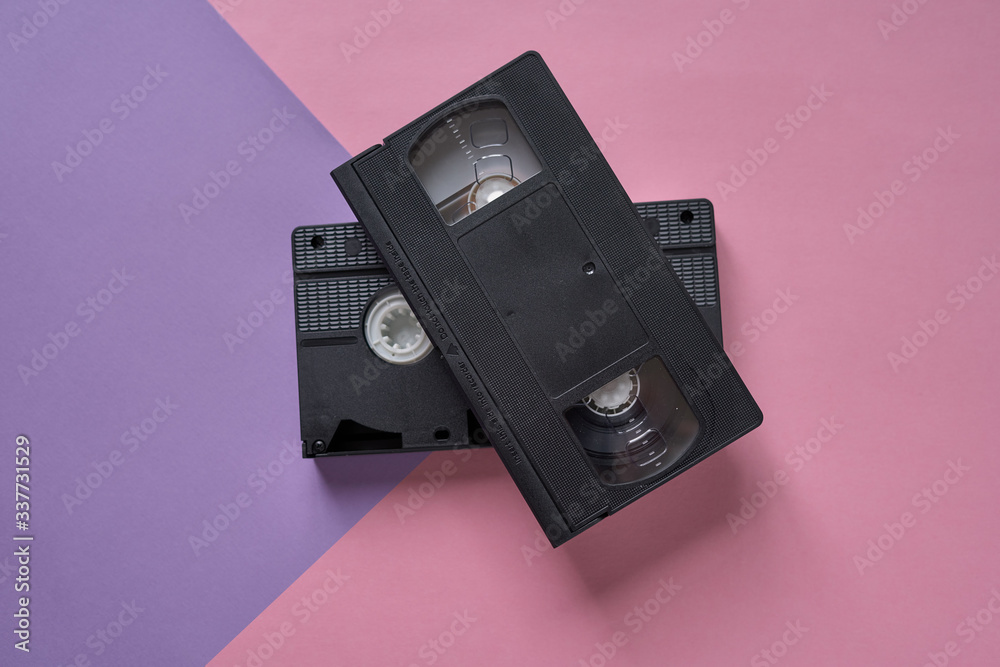 w VHS video tapes overlays on a pink and purple background. Stock Photo ...