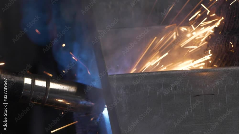 Welder works in metal construction - construction and processing of ...