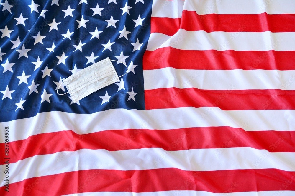 Protective surgical face mask on American national flag. U.S. flag and ...