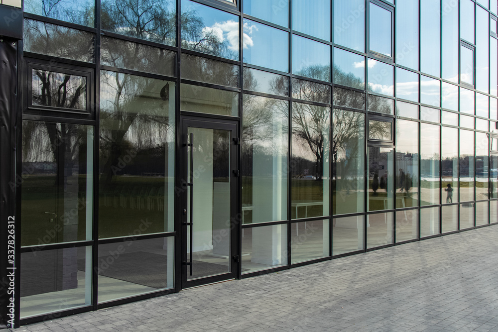 office center glass exterior wall building paved street walk side urban ...