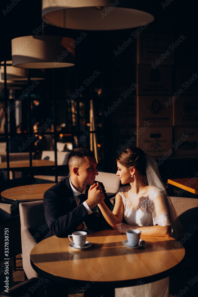 The groom hugs the bride and they look each other. Beautiful elegant ...