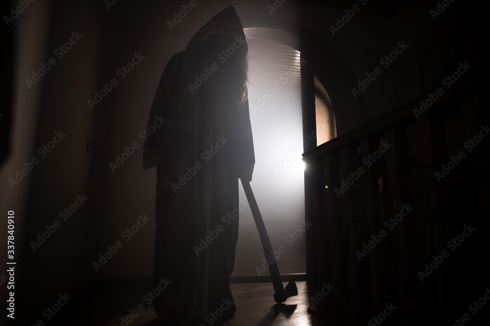 Silhouette of an unknown shadow figure on a door through a closed glass ...