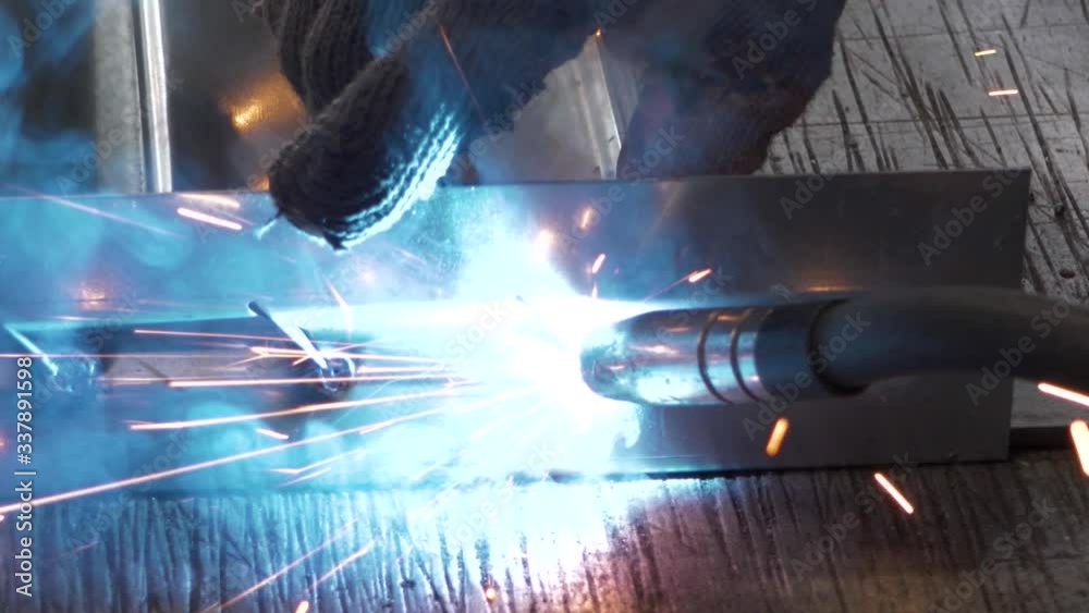 Welder works in metal construction - construction and processing of ...