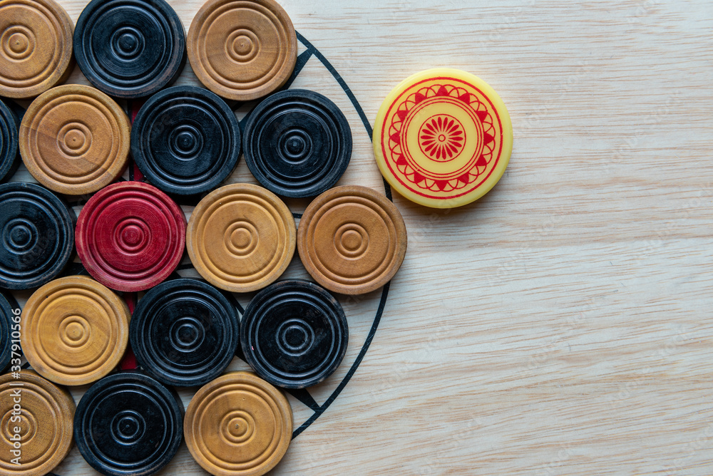 Carrom men and red arranged on the board around the center star. Stock ...