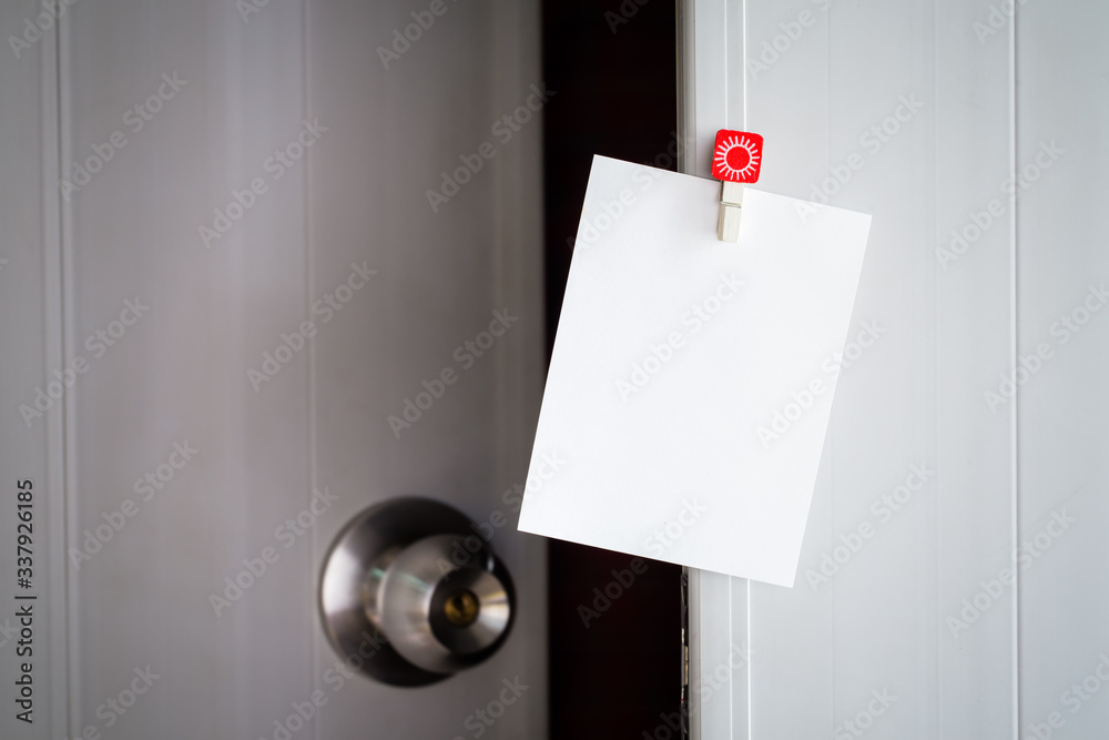 The white door with metal doorknob is lock and sticker paper note on ...