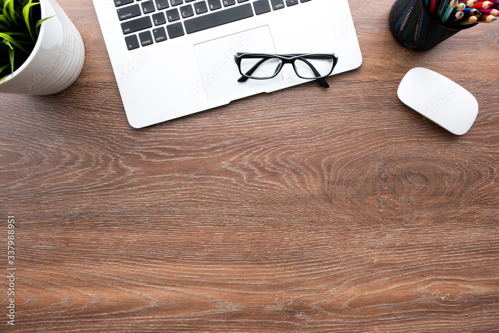 Wood office desk table with laptop computer and office supplies. Top ...