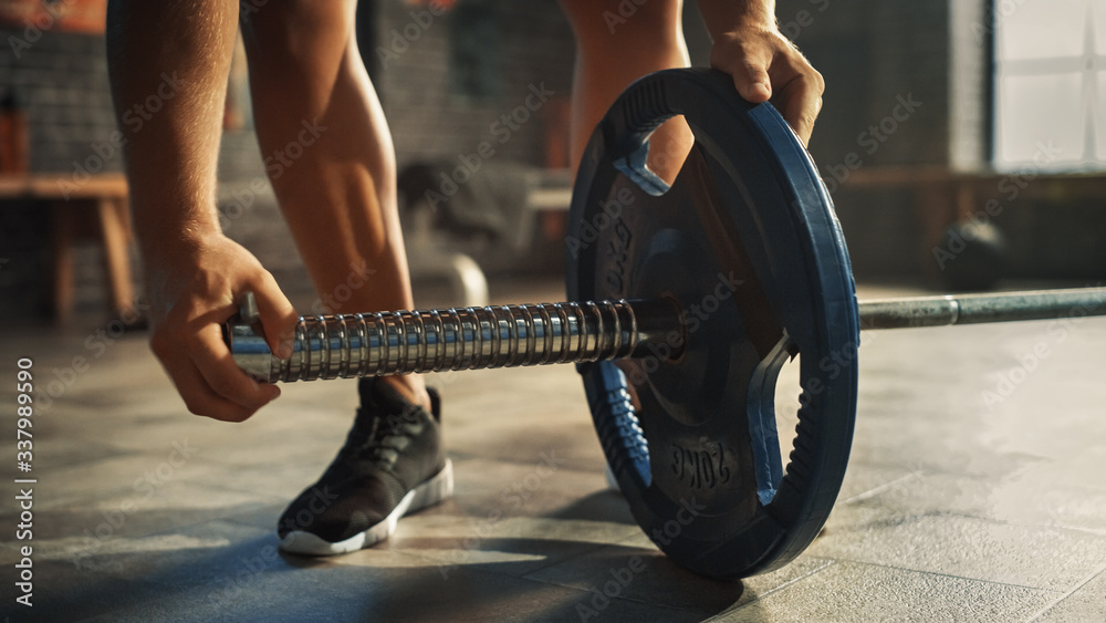 Close-up Shot of Bodybuilder Puts Additional Weights on a Barbell ...