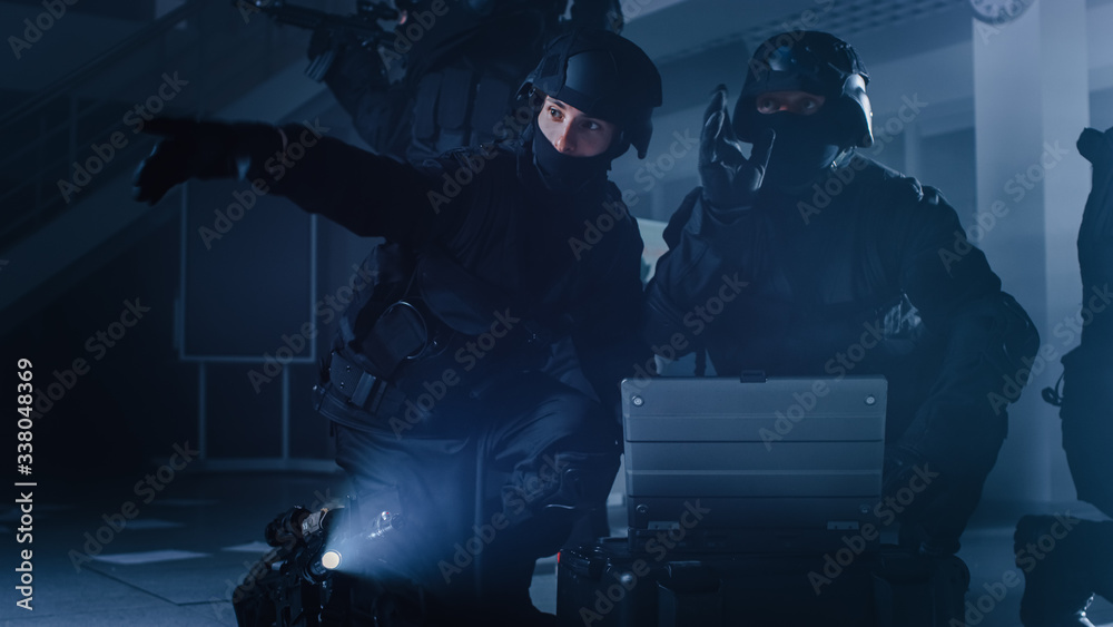 Masked Team of Armed SWAT Police Officers with Rifles are in Dark ...