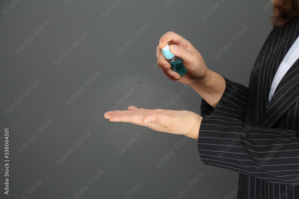 Hand of lady that applying alcohol spray or anti bacteria spray to ...