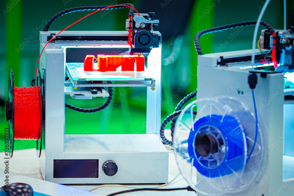 3D printers close up. Print objects from blue and red materials. Method ...