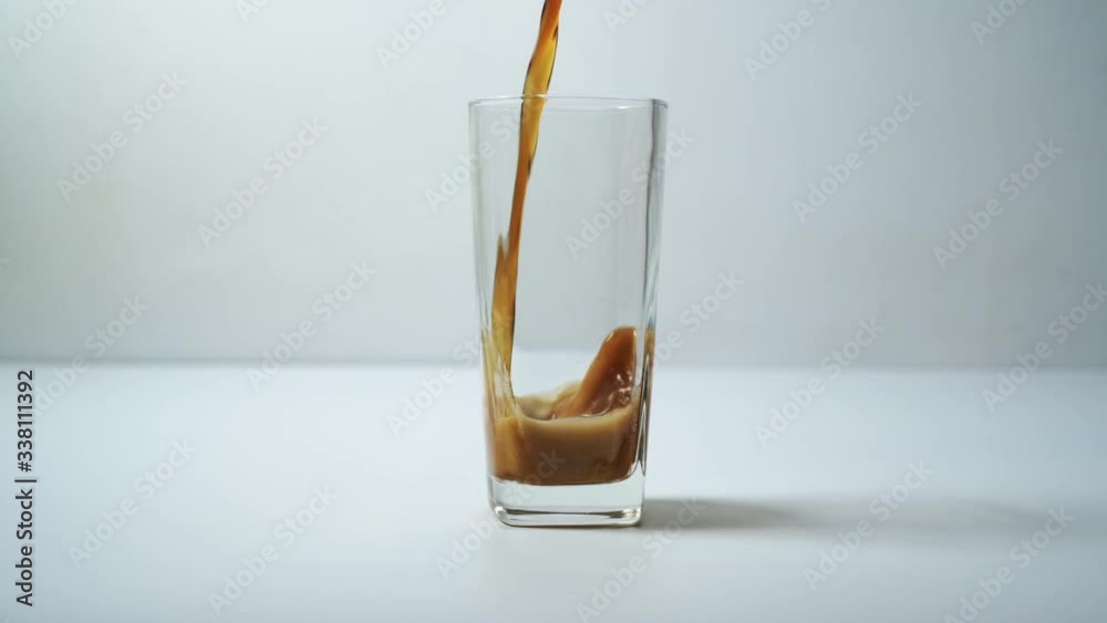 Refreshing cola flavored in the glass with soda bubbles on white back ...