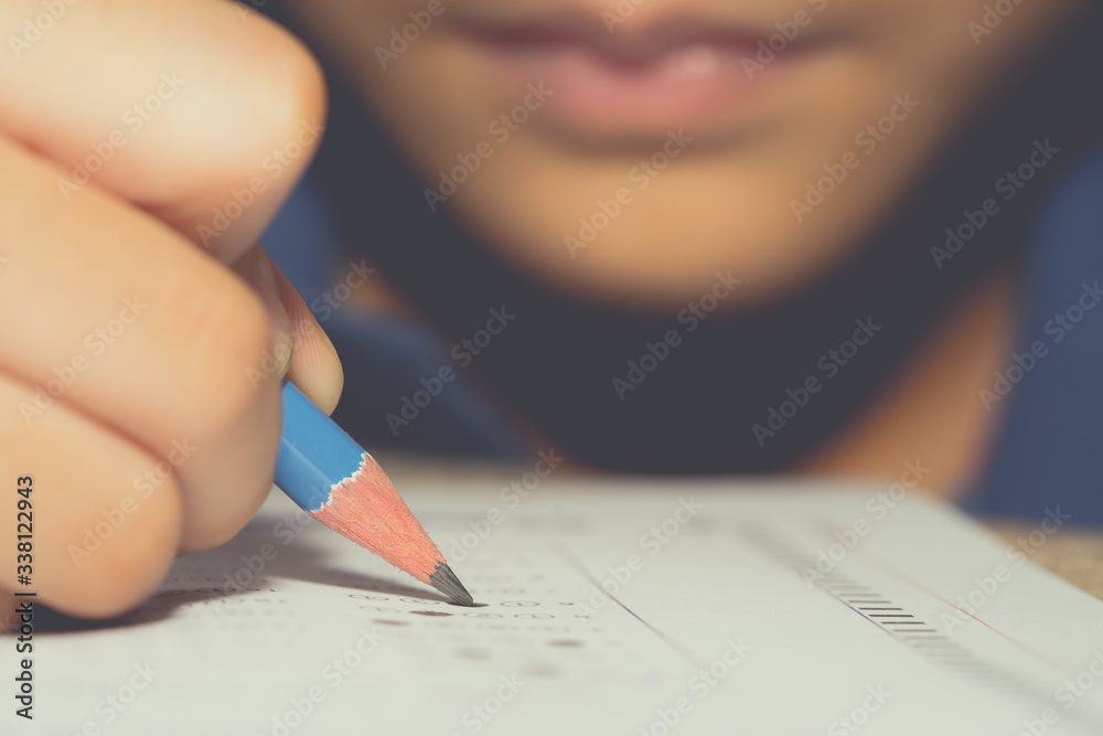 Test exam concept, pencil writing answer on paper answer of question in ...