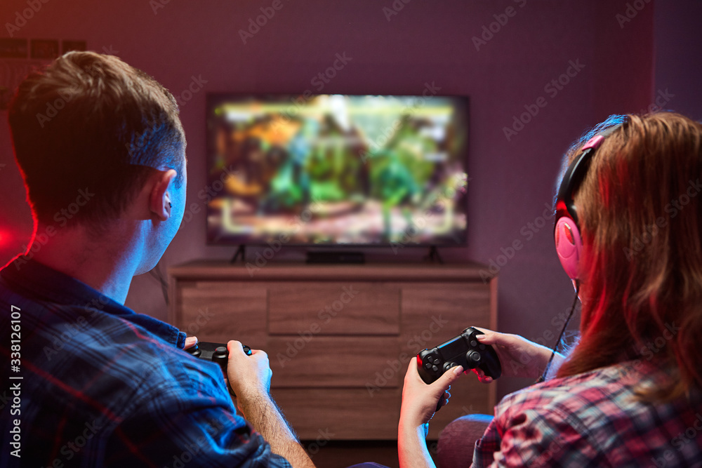 Portrait of crazy playful couple, Gamers enjoying Playing Video Games ...