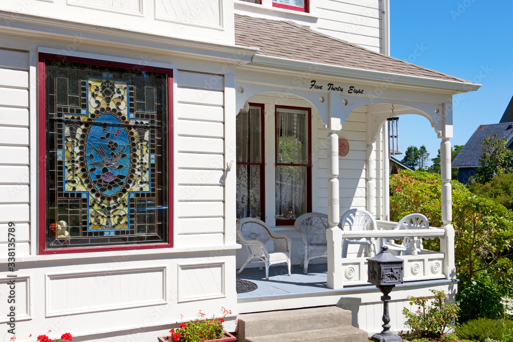 Historical white American house , WA with stain glass window and white ...