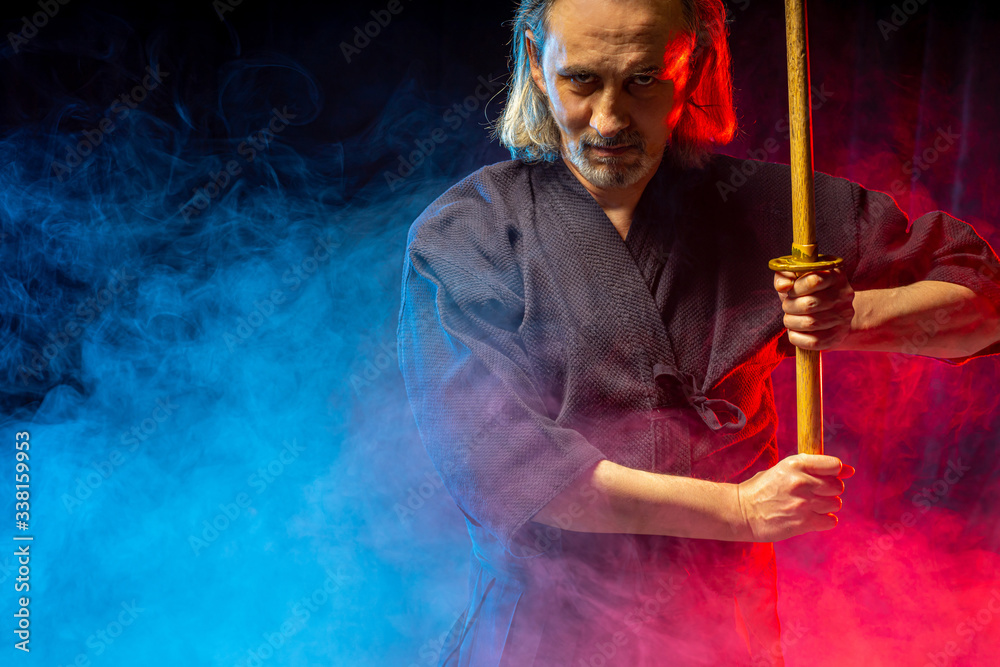 strong caucasian kendo fighter in traditional clothes. japanese martial ...