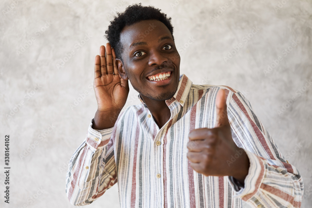 Isolated image of positive attractive young dark skinned guy making ...