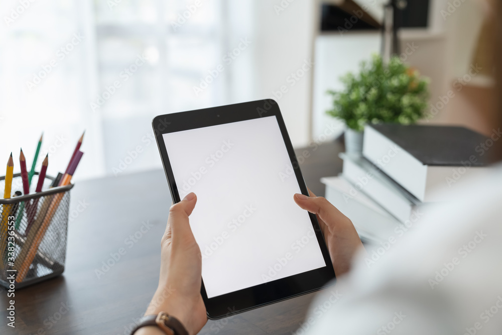 Closeup of woman hand holding digital tablet on the table and the ...