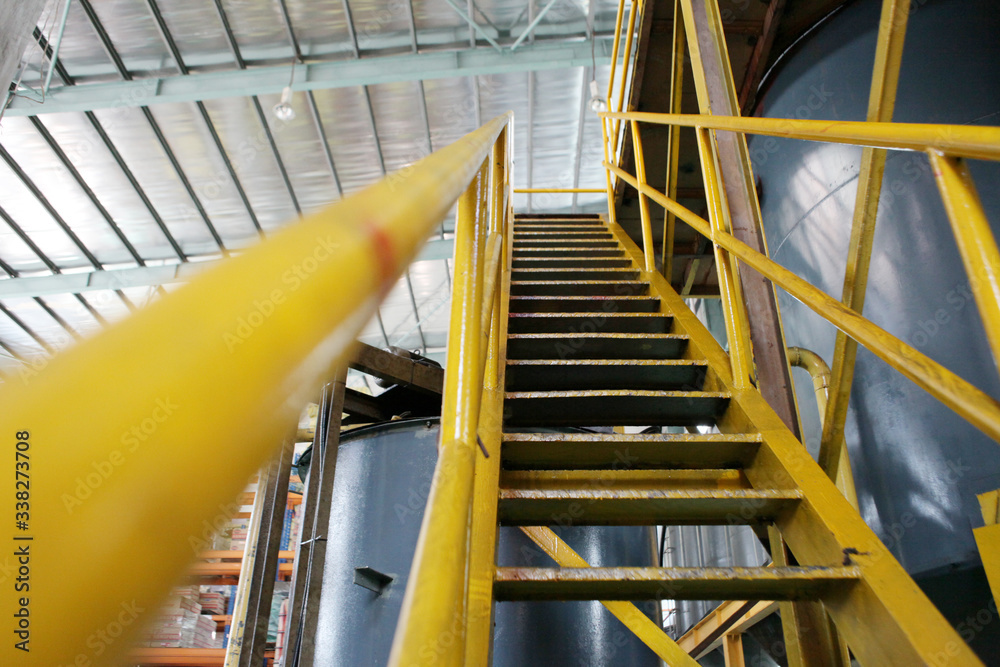 The handrail yellow stair for fire escape with the steel wall of the ...