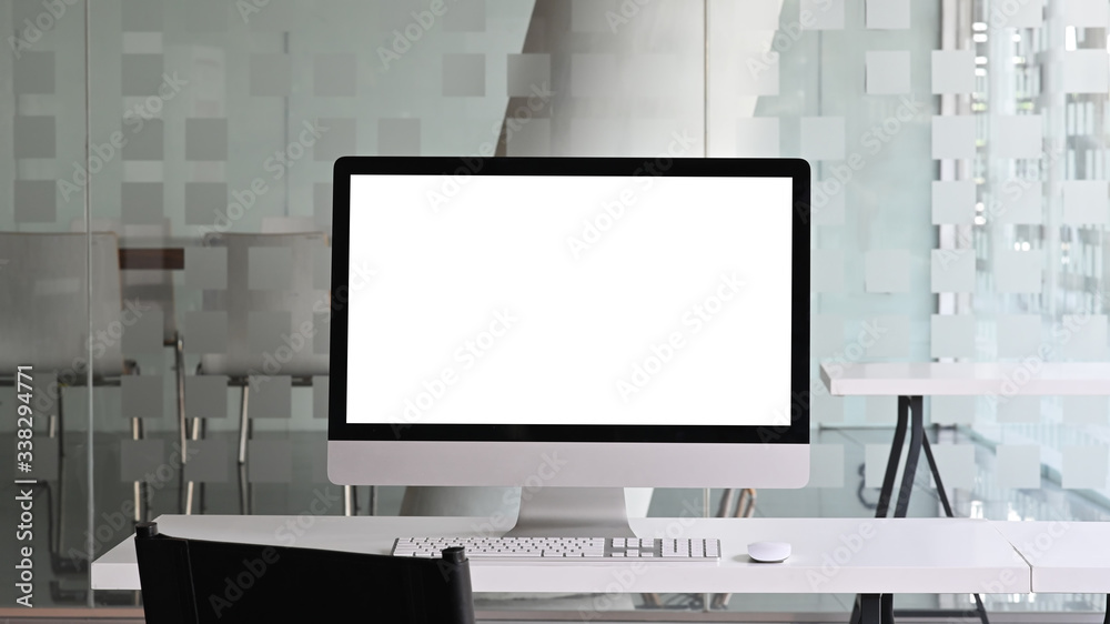 White blank screen monitor putting on white working desk with wireless ...