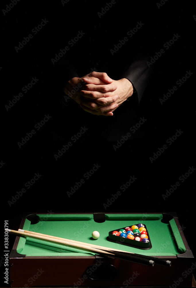 Staged photo of male hands with interlocked fingers over table ...