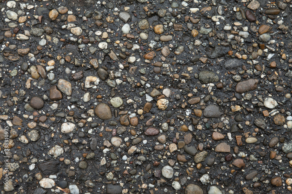 Wet homemade exposed aggregate concrete. Damp beton with visible brash ...