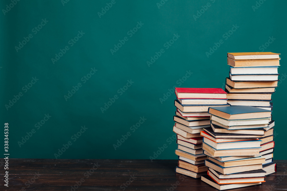 many stacks of educational books to teach in the school library on a ...