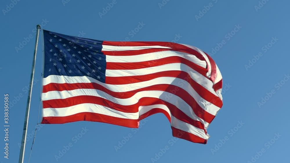 American USA flag on a flagpole waving in the wind. Slow Motion USA ...