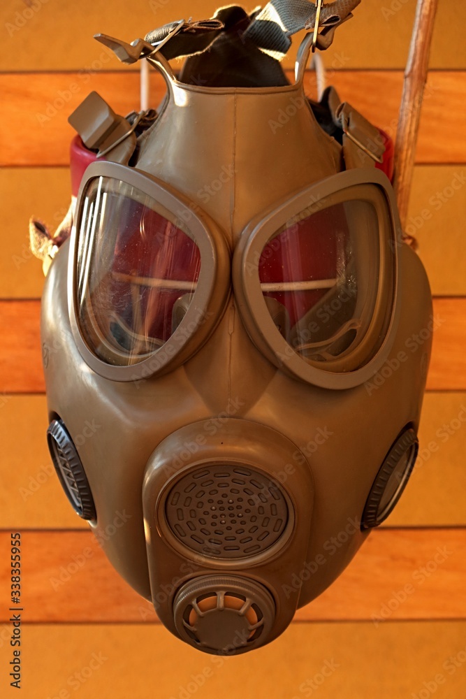 Front view of military grade M10 gas mask hanged on flower pot attached ...