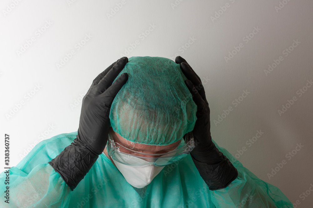 Male nurse, with plastic protective eyeglasses and respirator ffp2, cap ...