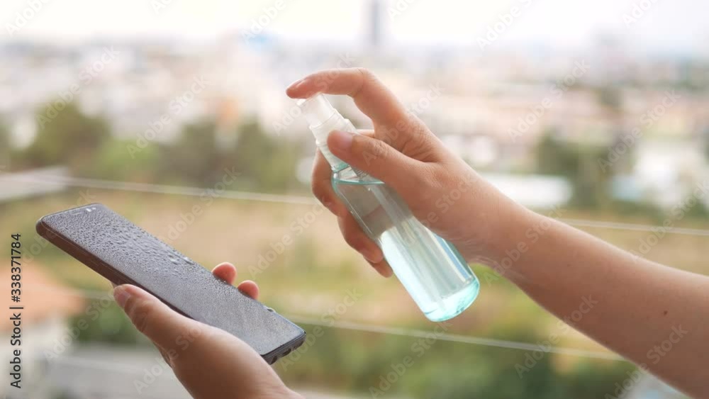 disinfect, sanitize, hygiene care. inject alcohol spray on mobile phone ...
