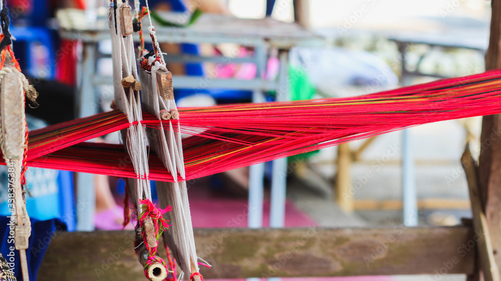 Tribal women are weaving with hand-made loom with wood, an ancient ...