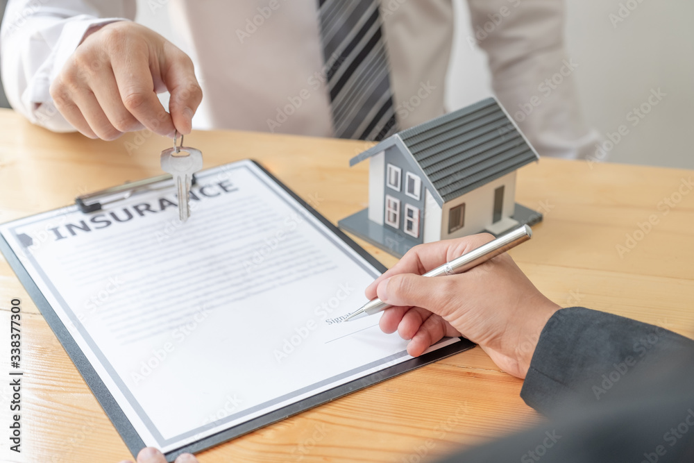 Real estate agent broker hand over the house key to the new owner after ...