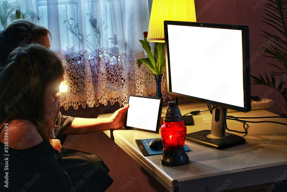 Young women in mourning are looking on computer screen and crying ...