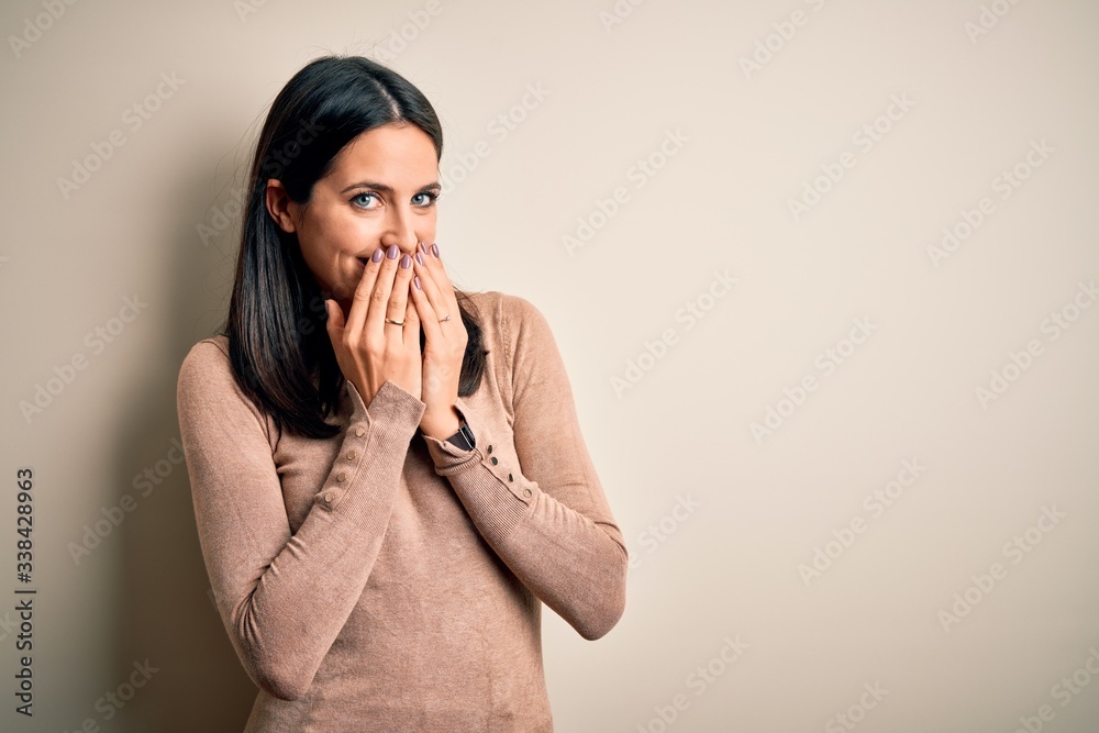 Young brunette woman with blue eyes wearing casual sweater over ...