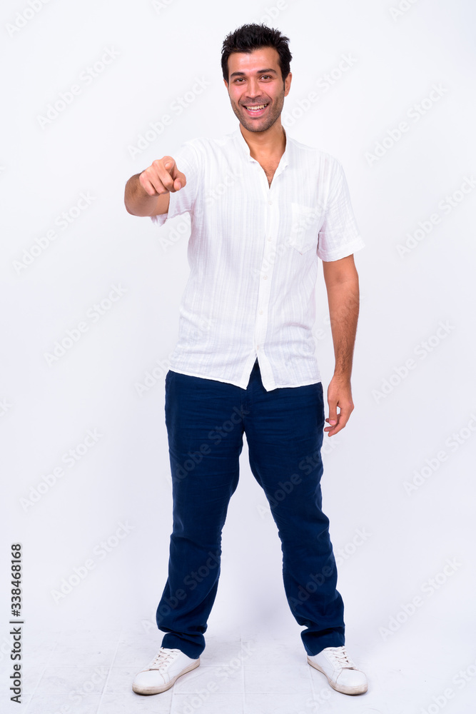 Full body shot of happy handsome Turkish man pointing at camera Stock ...