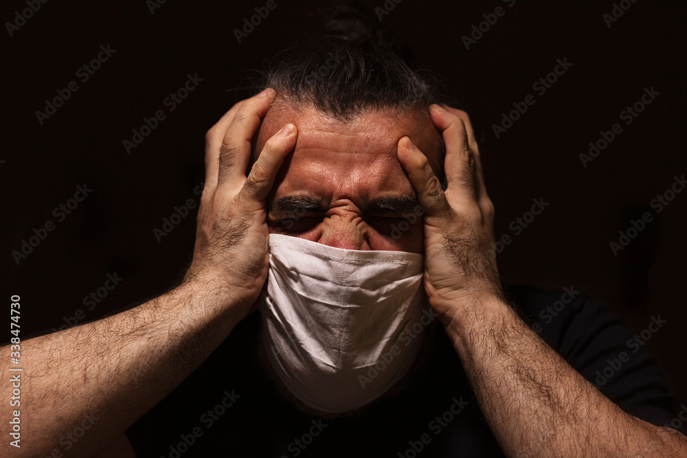 Man wearing white medical face mask as prevention from spreading ...