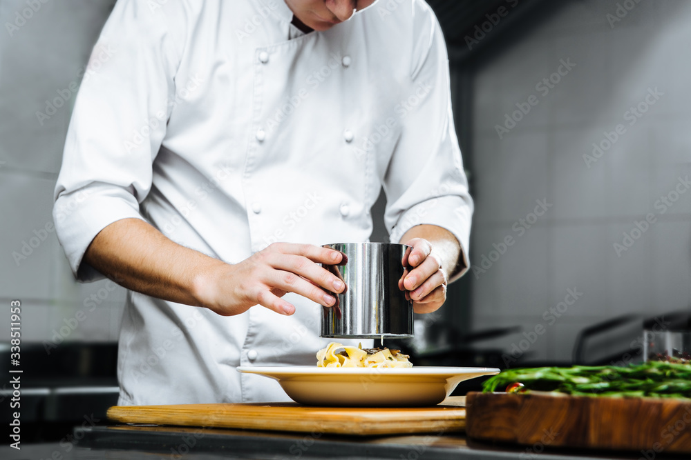 Restaurant chef cooking italian cuisine dish pasta fettuccine on the ...