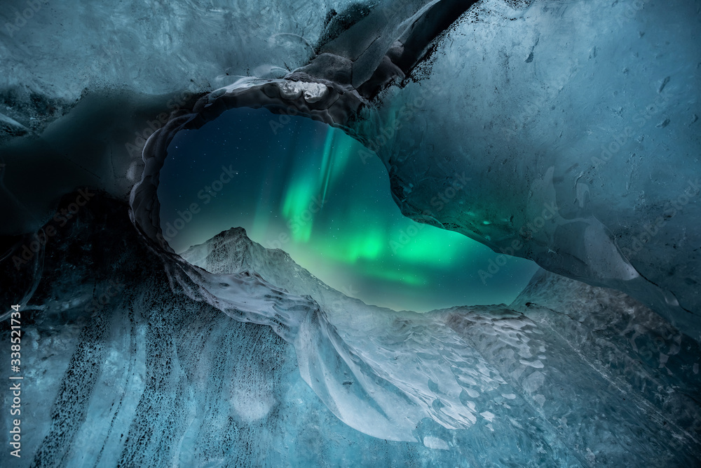 Northern lights aurora borealis over glacier ice caves in Iceland Stock ...