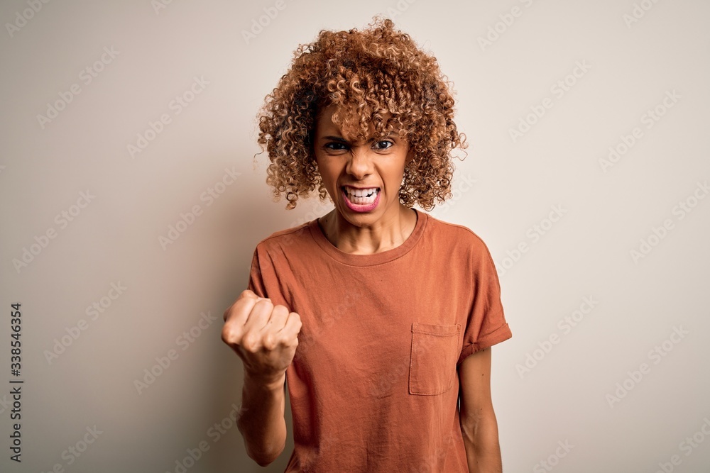 Beautiful african american woman with curly hair wearing casual t-shirt ...