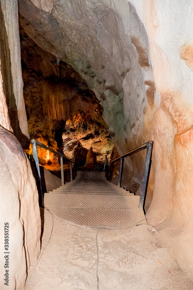 tourist cave .High arches of a huge stone cave with round holes at the ...
