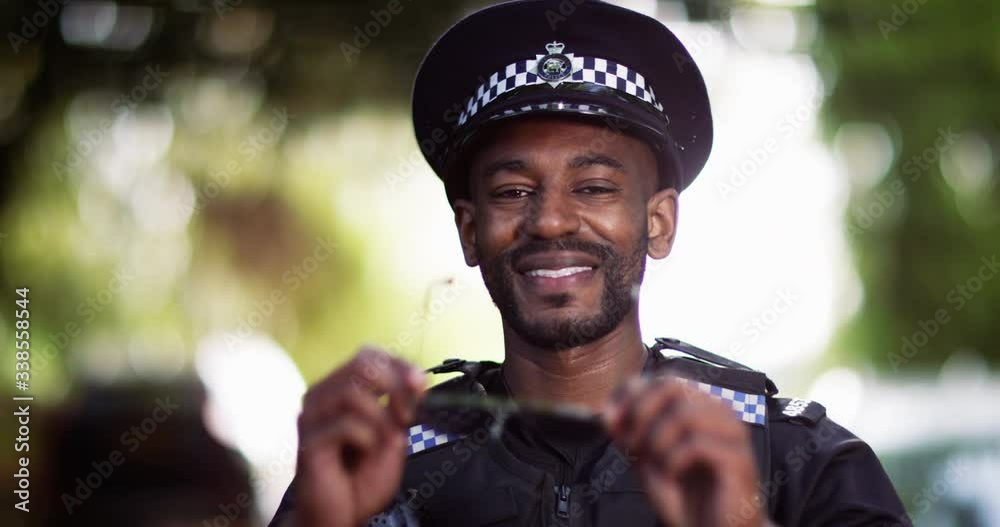 4K Close up of friendly police officer taking off sunglasses & smiling ...